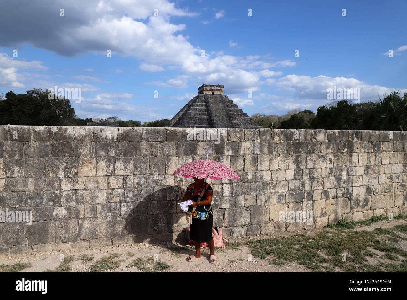 A vendor of souvenirs waits for visitors during the Spring equinox near ...