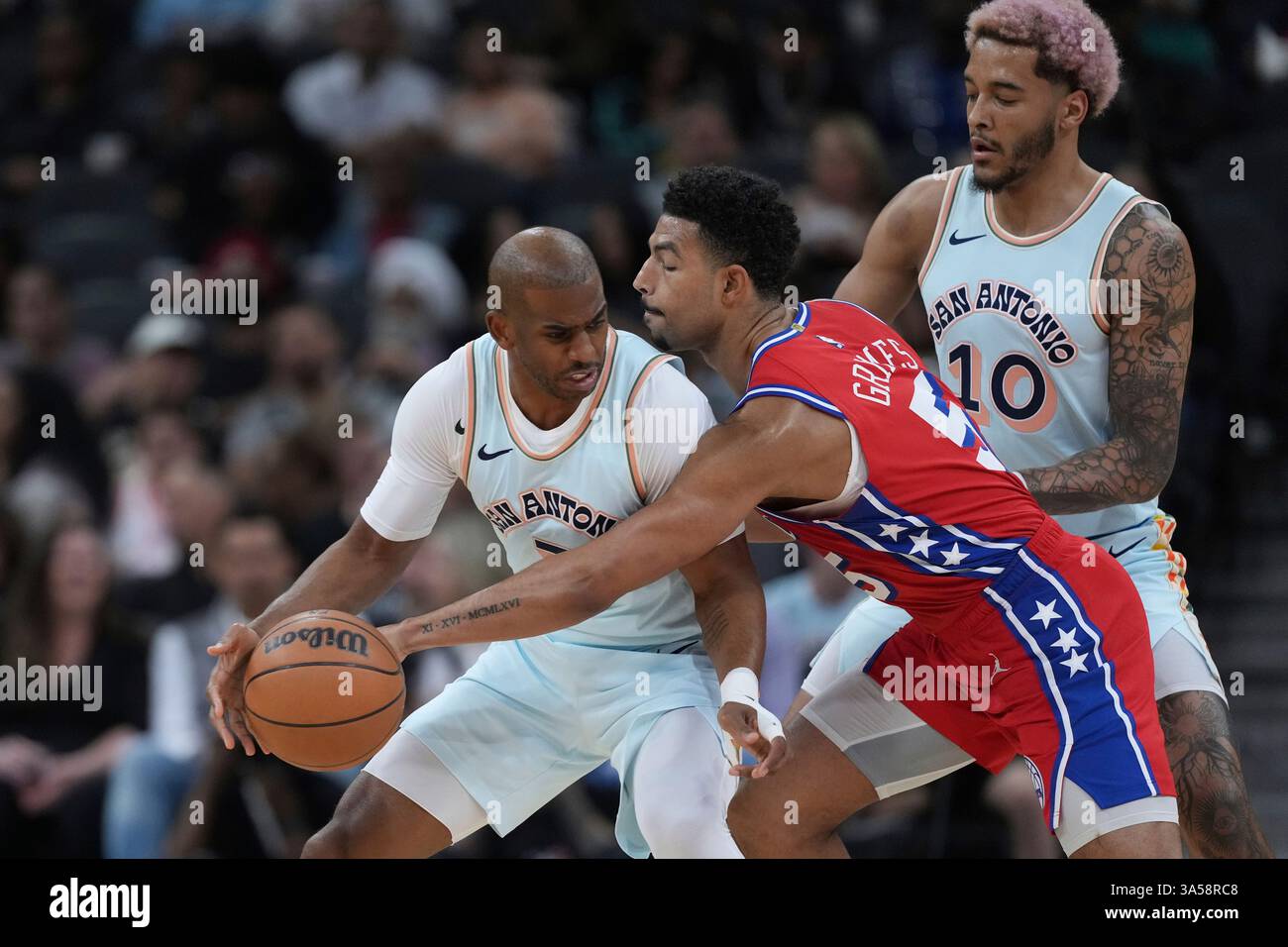 Philadelphia 76ers guard Quentin Grimes, center, reaches in on San ...