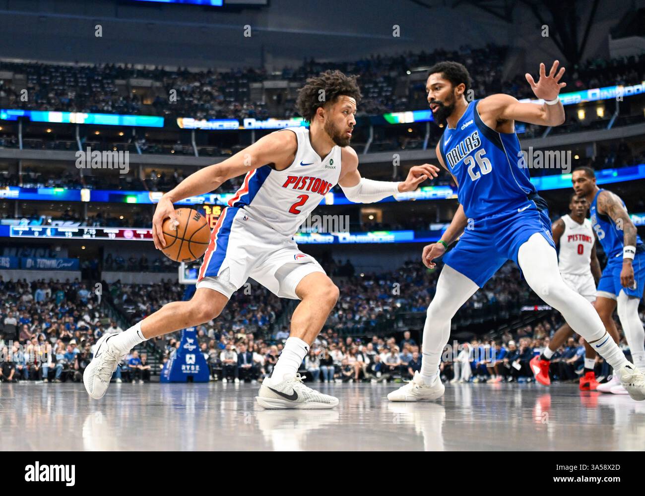 Detroit Pistons guard Cade Cunningham, left, drives against Dallas Mavericks guard Spencer ...