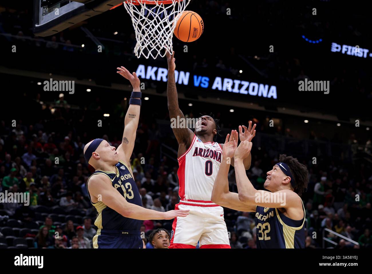 Arizona guard Jaden Bradley, center, shoots against Akron guard Isaiah ...