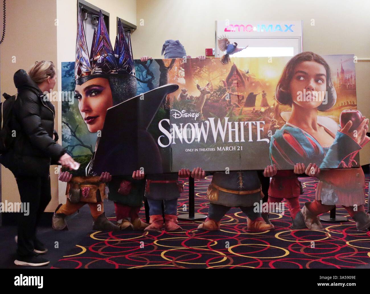 Promotional signs for Disney's Snow White are on display at an IMAX ...