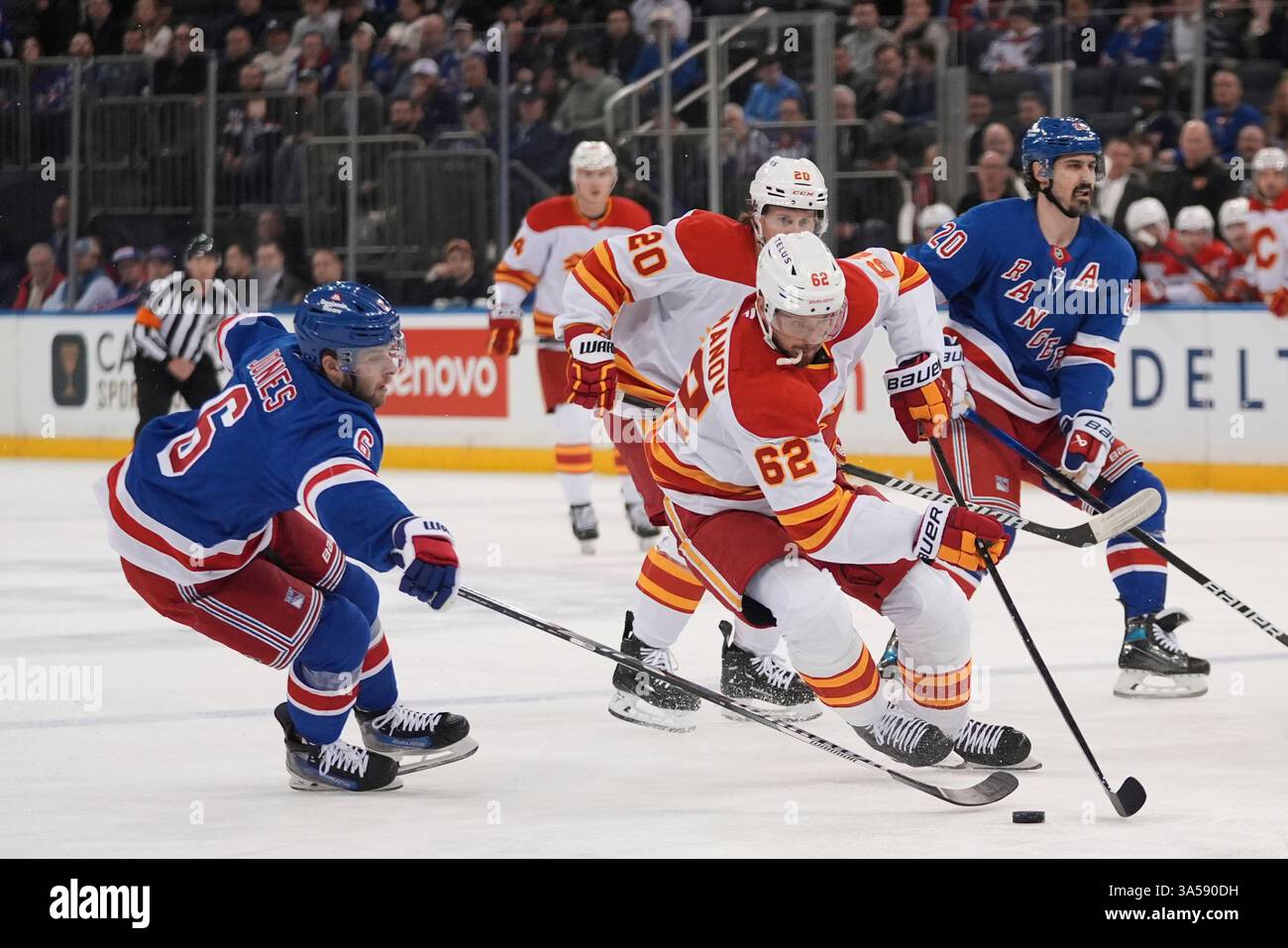Calgary Flames' Daniil Miromanov (62) drives past New York Rangers' Zac ...