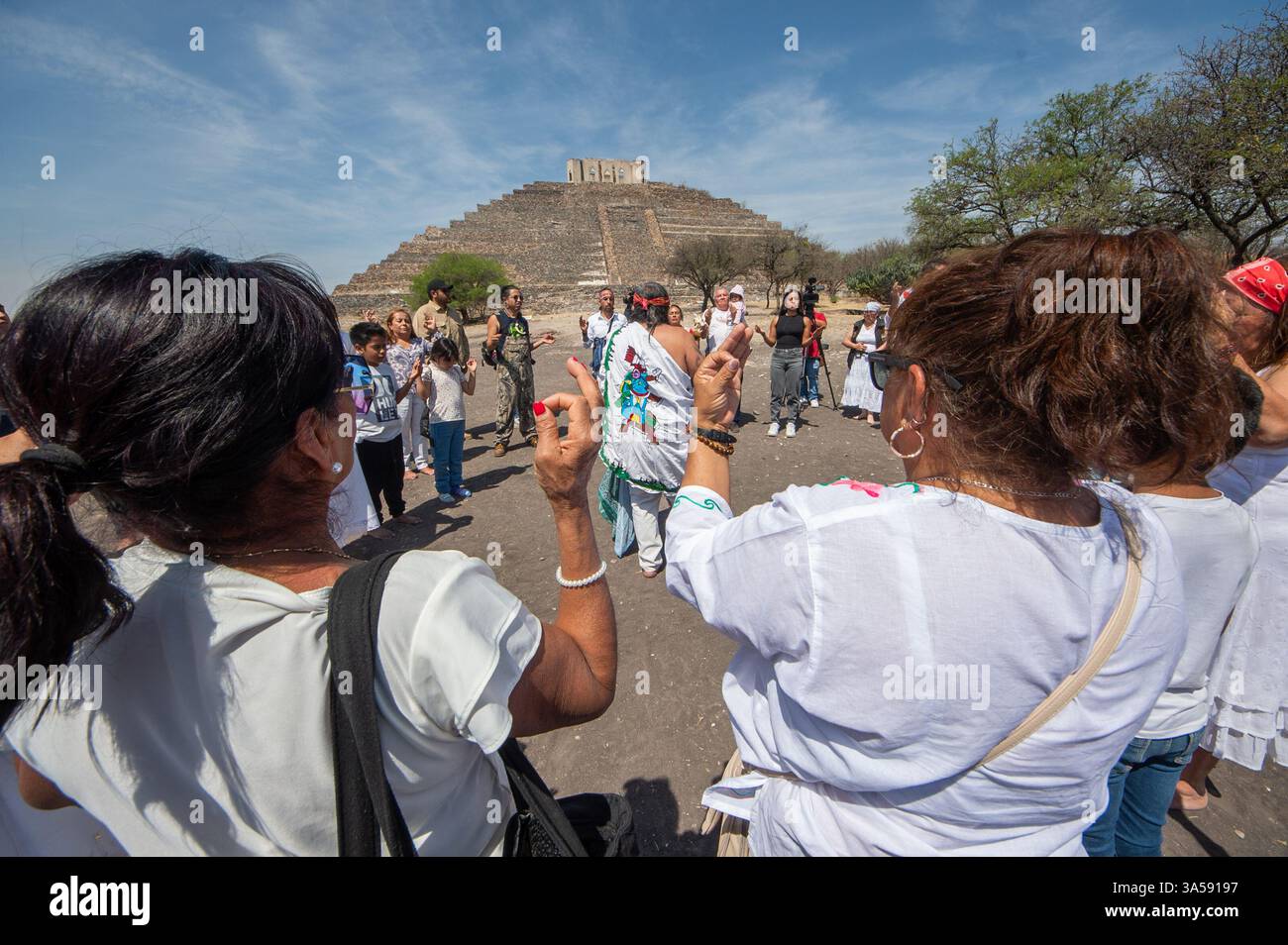 People rise their hands during a ritual to recharge themselves with ...