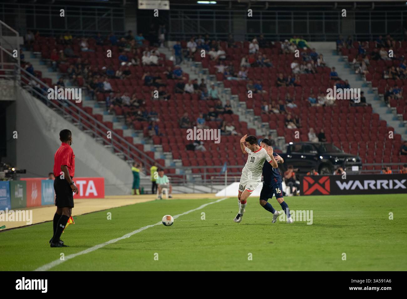 THANAWAT SUENGCHITTHAWON #16 of Thailand goes for the ball against ...