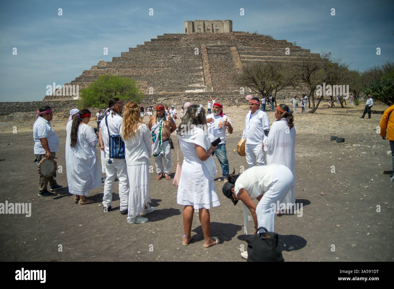 People rise their hands during a ritual to recharge themselves with ...