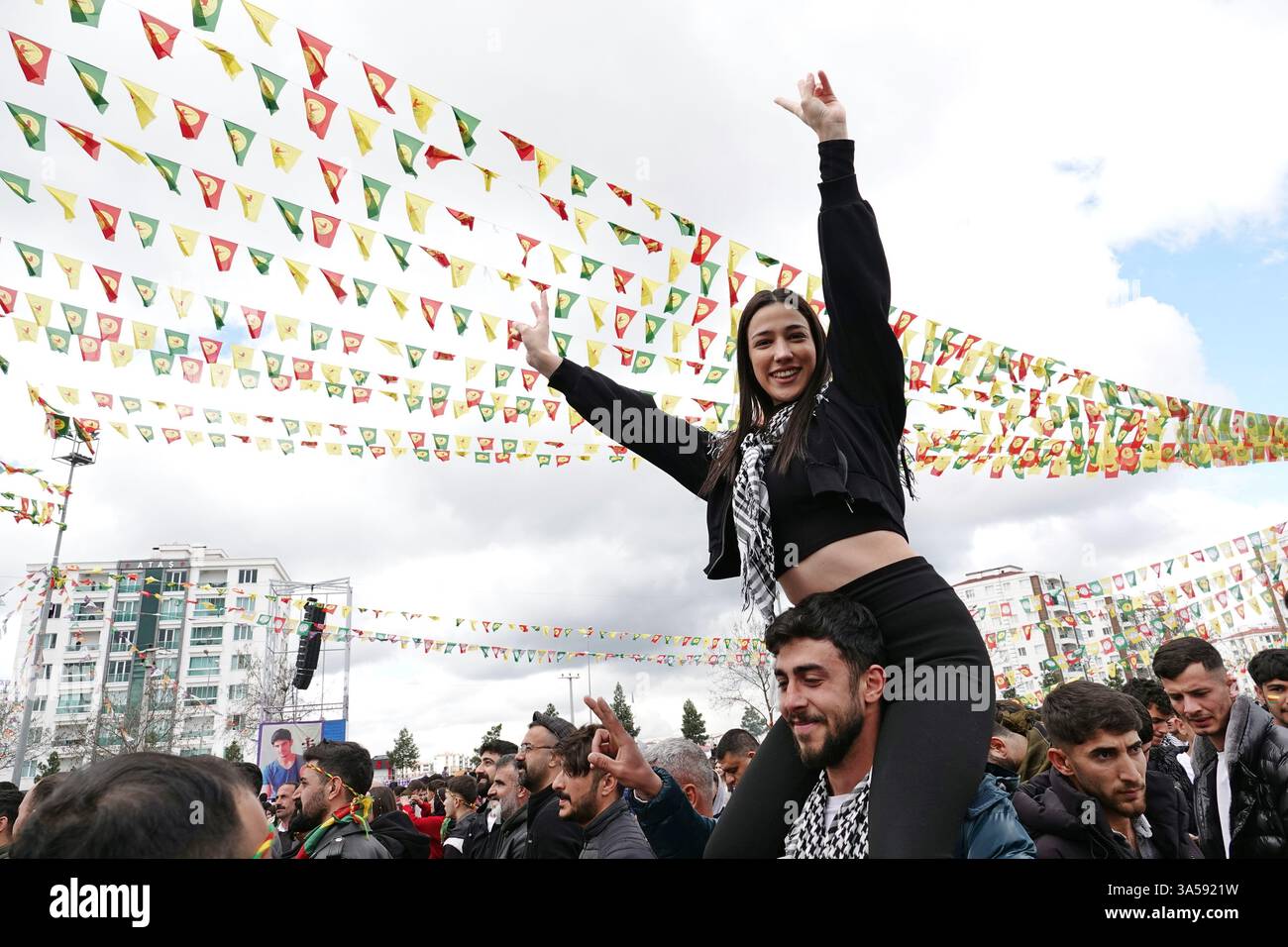 A young Kurdish woman is seen making a victory sign during the Newruz ...
