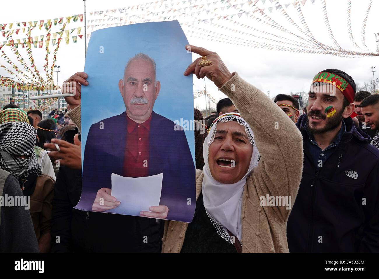 A female demonstrator holds a poster of Abdullah Ocalan, the leader of ...