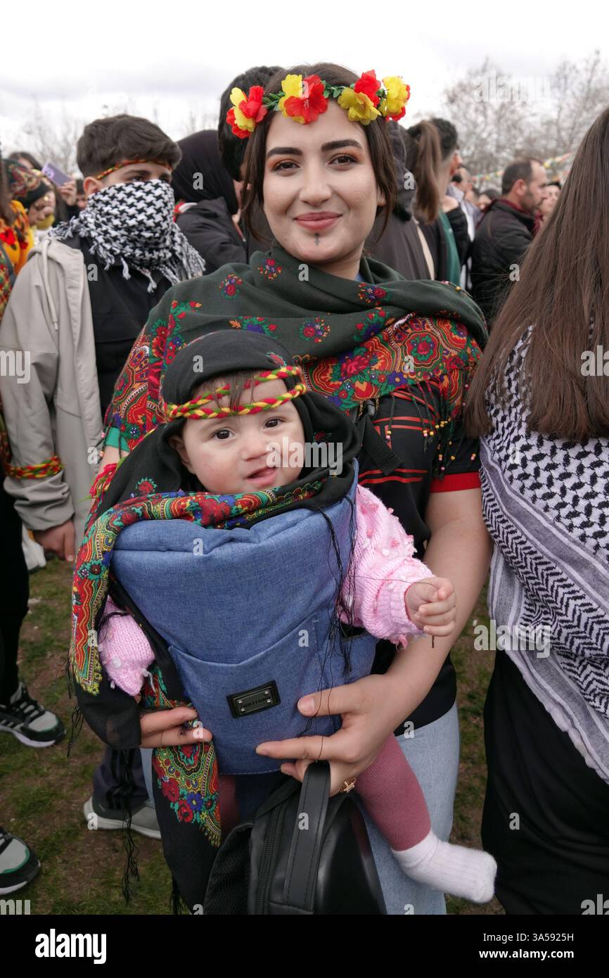 A Kurdish woman is seen attending the Newruz celebration with her baby ...