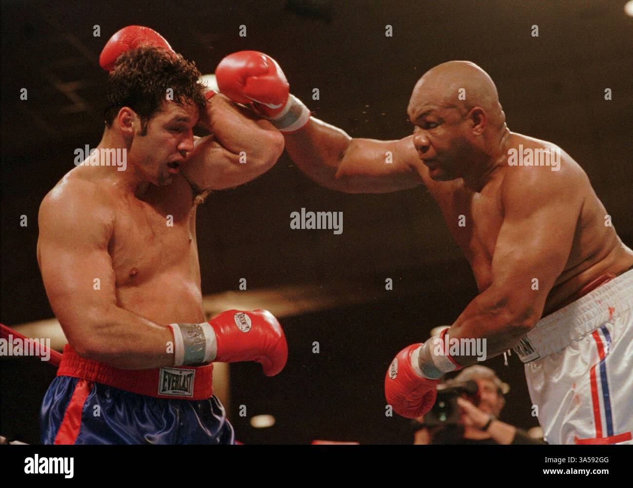 FILE - Lou Savarese of New York City blocks a right from George Foreman ...