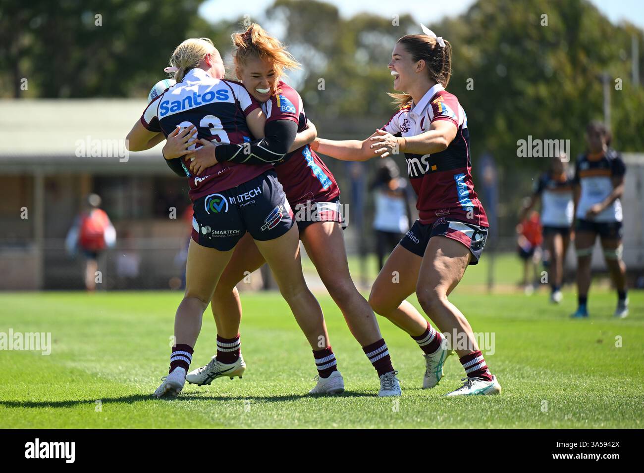 Piper Flynn of the Reds celebrates with team mates after scoring a try ...