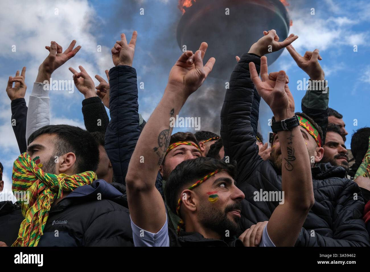 Diyarbakir, Turkey. 21st Mar, 2025. People gesture during the ...