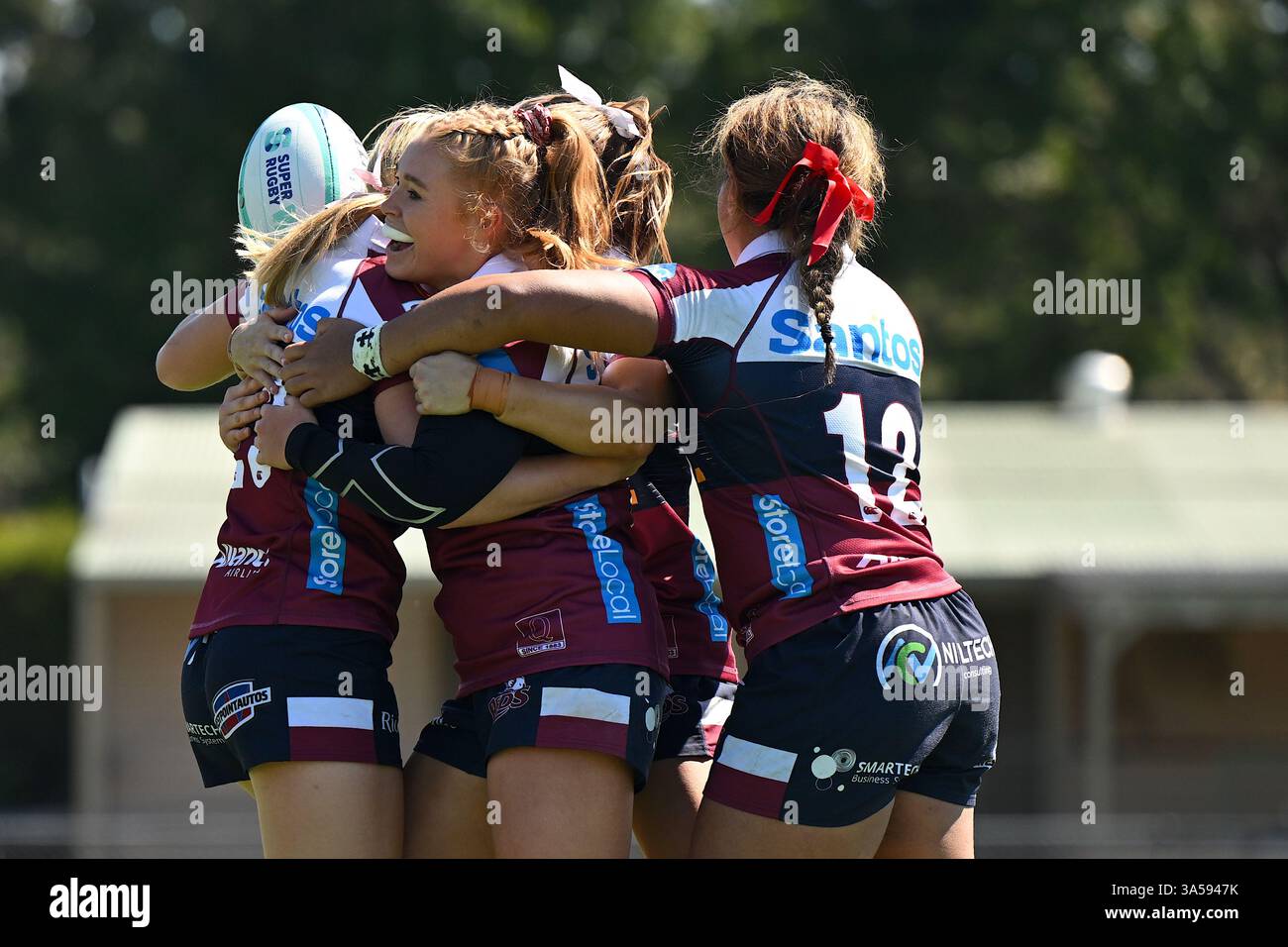 Piper Flynn of the Reds celebrates with team mates after scoring a try ...