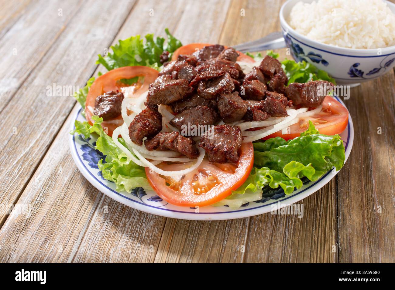 A view of a plate of shaking beef Stock Photo - Alamy