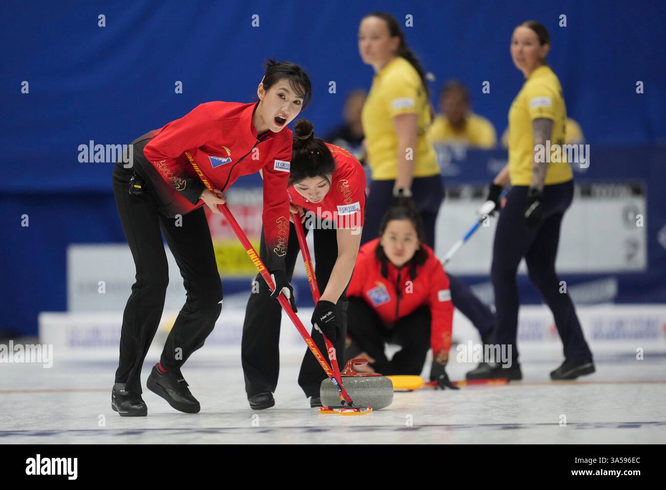 China's Jiang Jiayi, left, sweeps during the qualification match against Sweden at the World ...