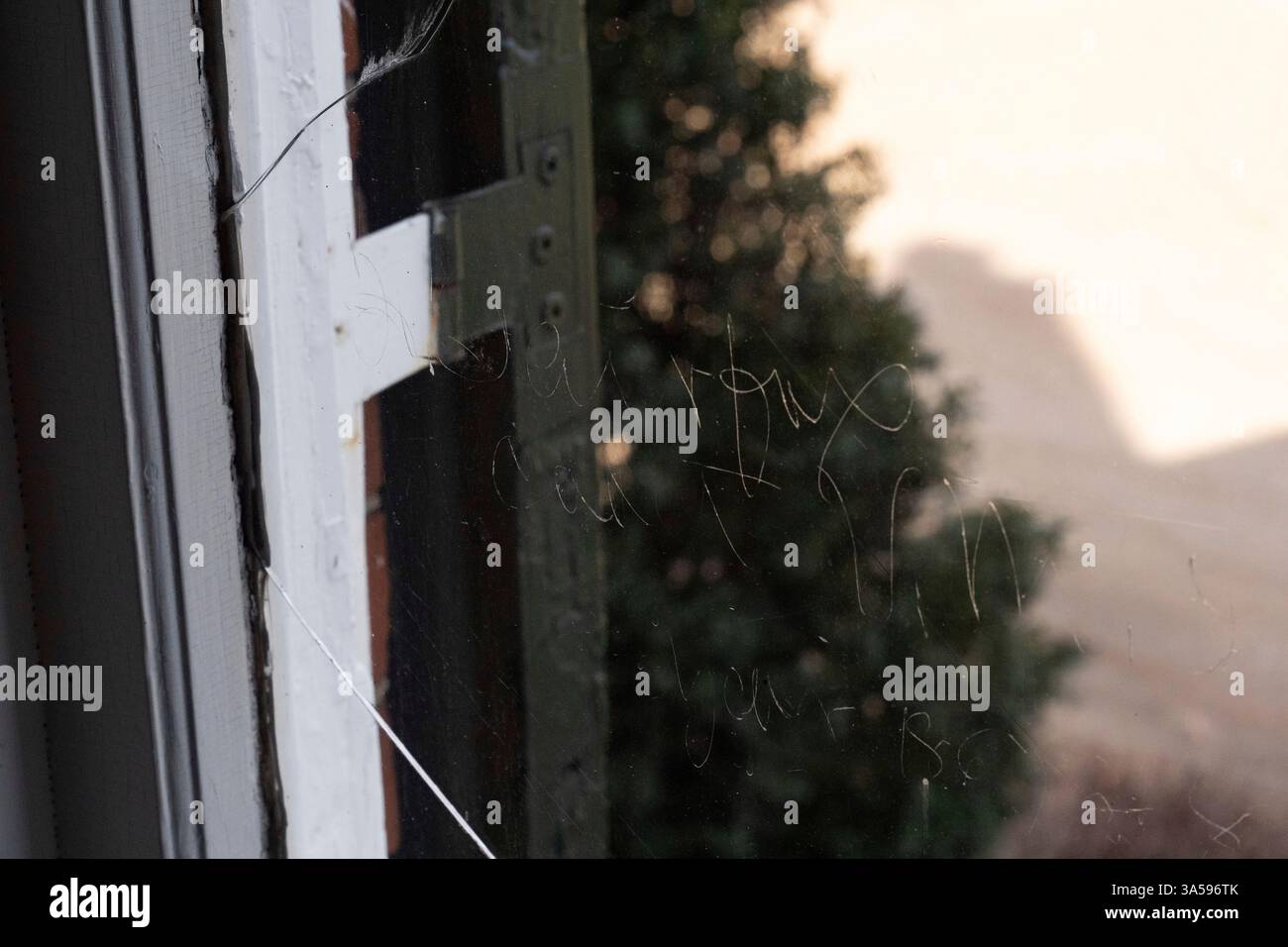 Etched writing is seen on a window of a bedroom in the main house at ...