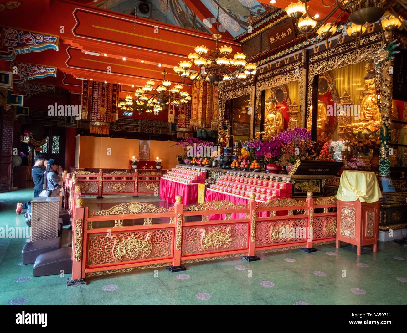 Tourists pray at Po Lin Monastery in Ngong Ping, Lantau Island, Hong ...