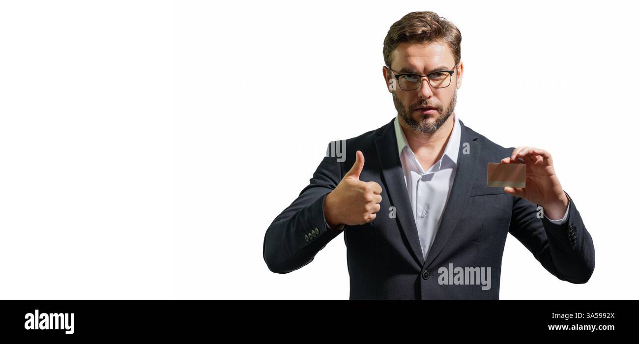 Studio portrait of man with a credit card on gray isolated background ...