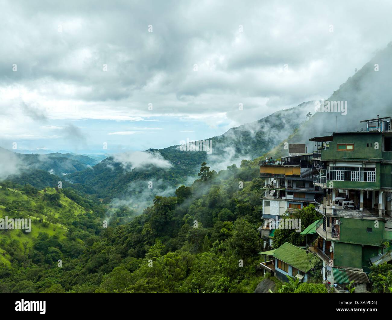 The image captures the misty valleys of Ella, Sri Lanka, with lush ...
