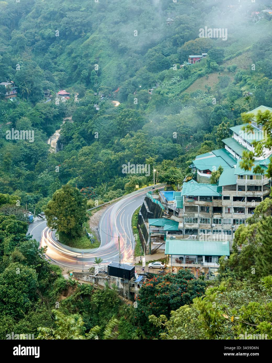 The image captures a winding mountain road in Ella, Sri Lanka, nestled ...