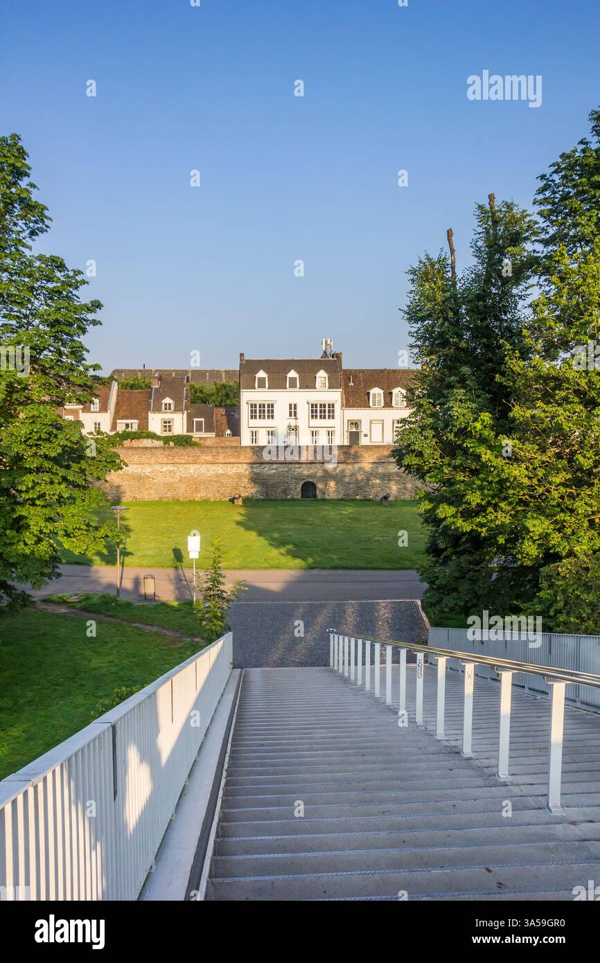 Stairs going down to the historic city wall with houses in Maastricht ...