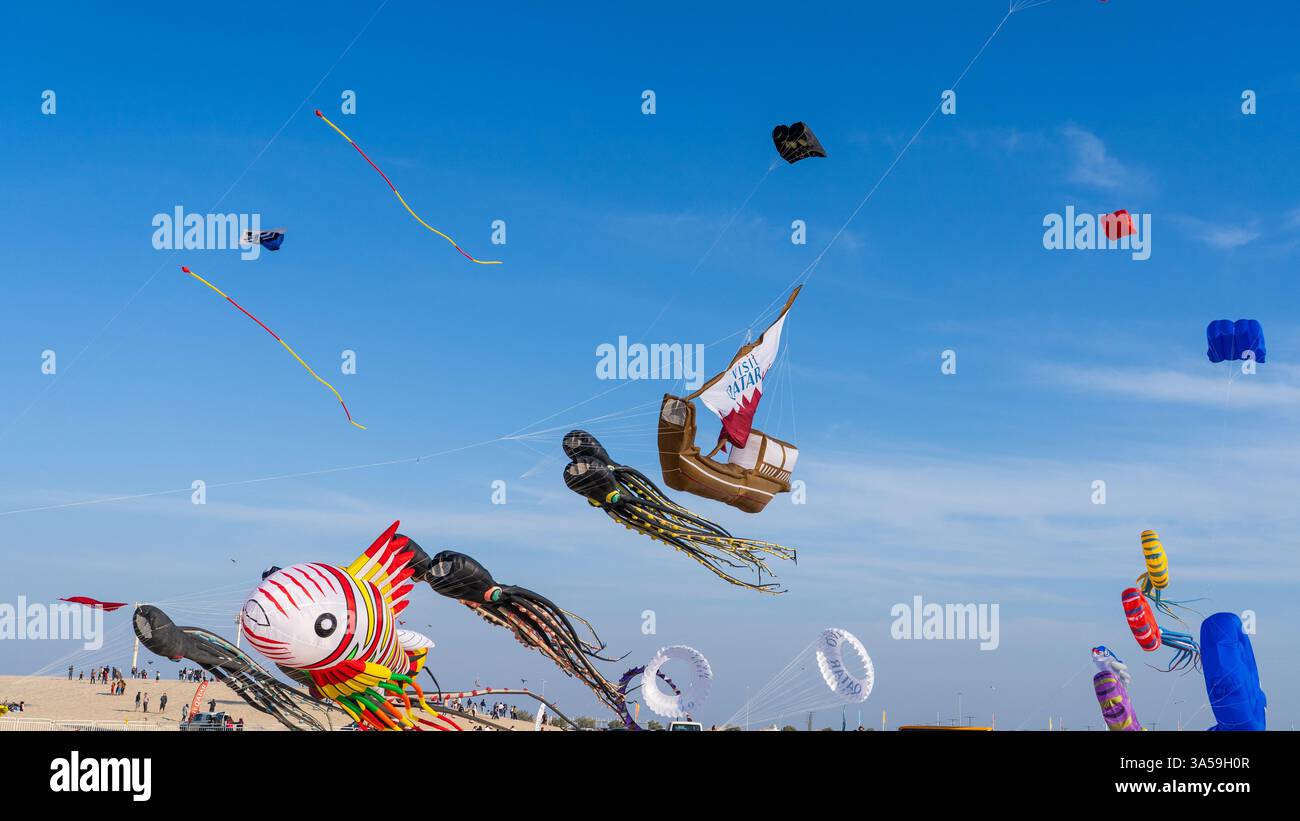 Sealine, Qatar - February 24, 2025: Colorful kites soar high above the ...