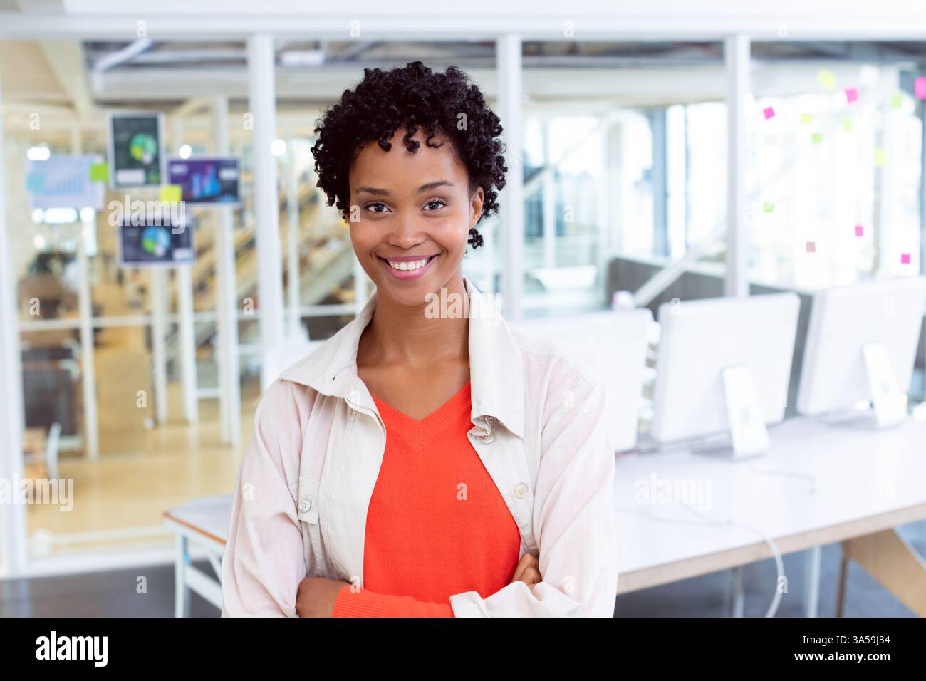 Confident African American woman smiling in modern office with ...
