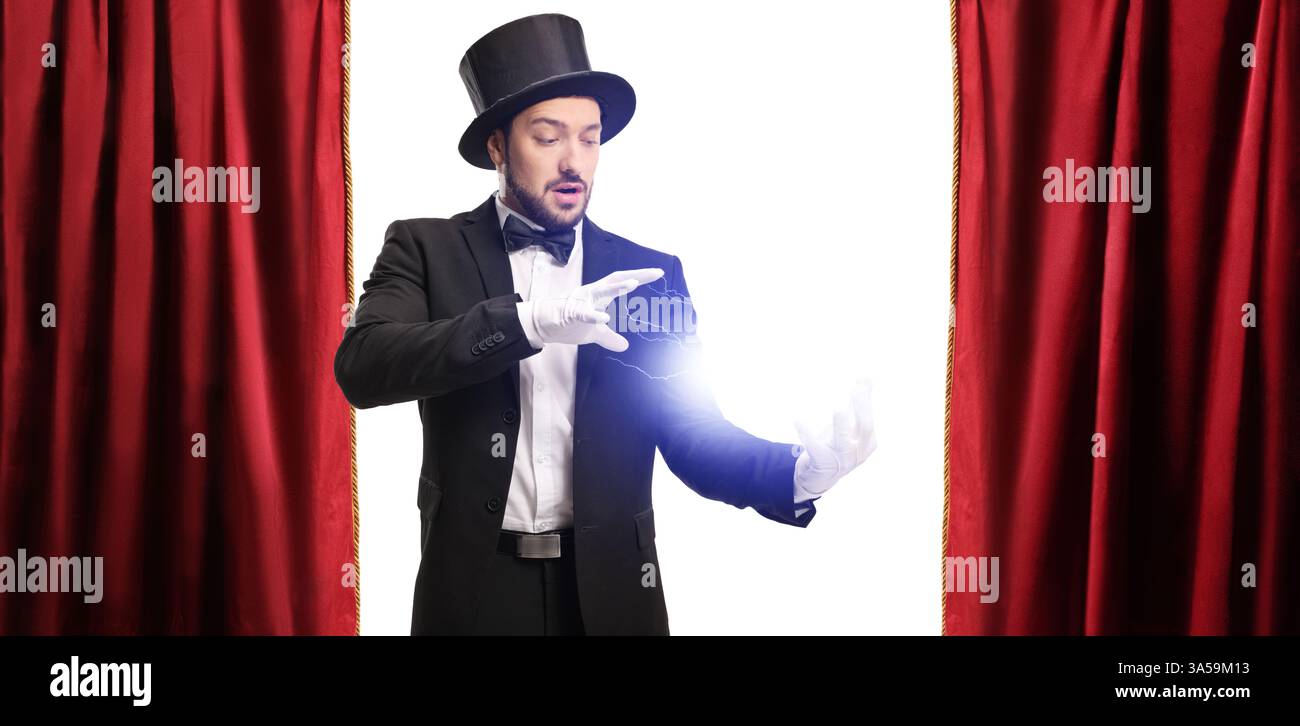 Magician performing a trick with electricity on stage isolated on white ...