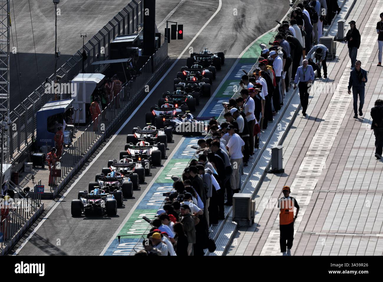 Jack Doohan (AUS) Alpine F1 Team A525 at the end of the queue of cars at the end of the pit lane ...