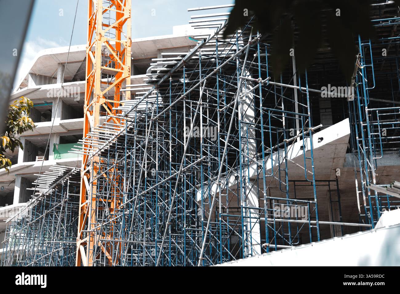 A bustling construction site featuring extensive scaffolding and a ...