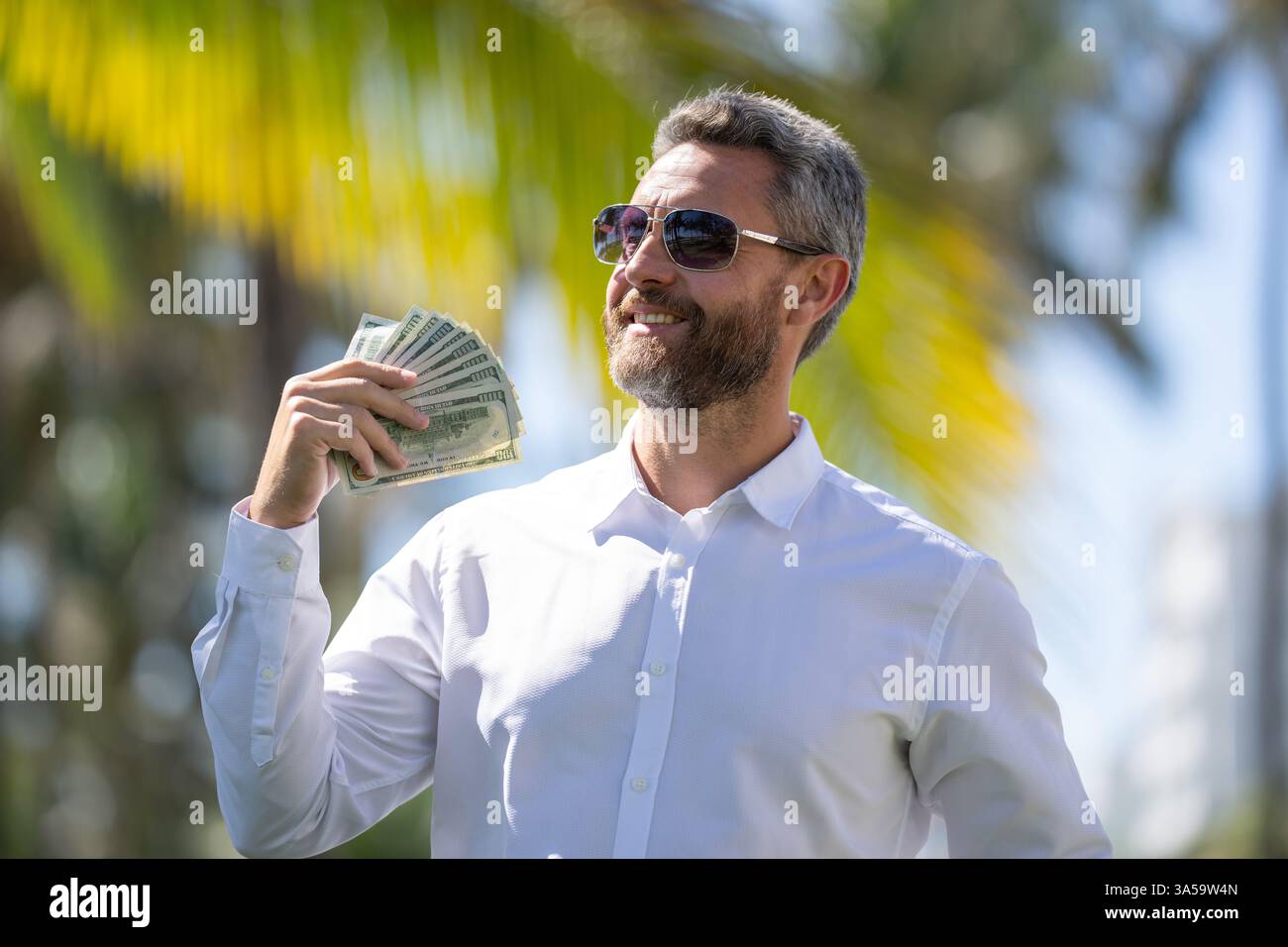 Rich businessman holding cash. Successful rich man counting dollar ...