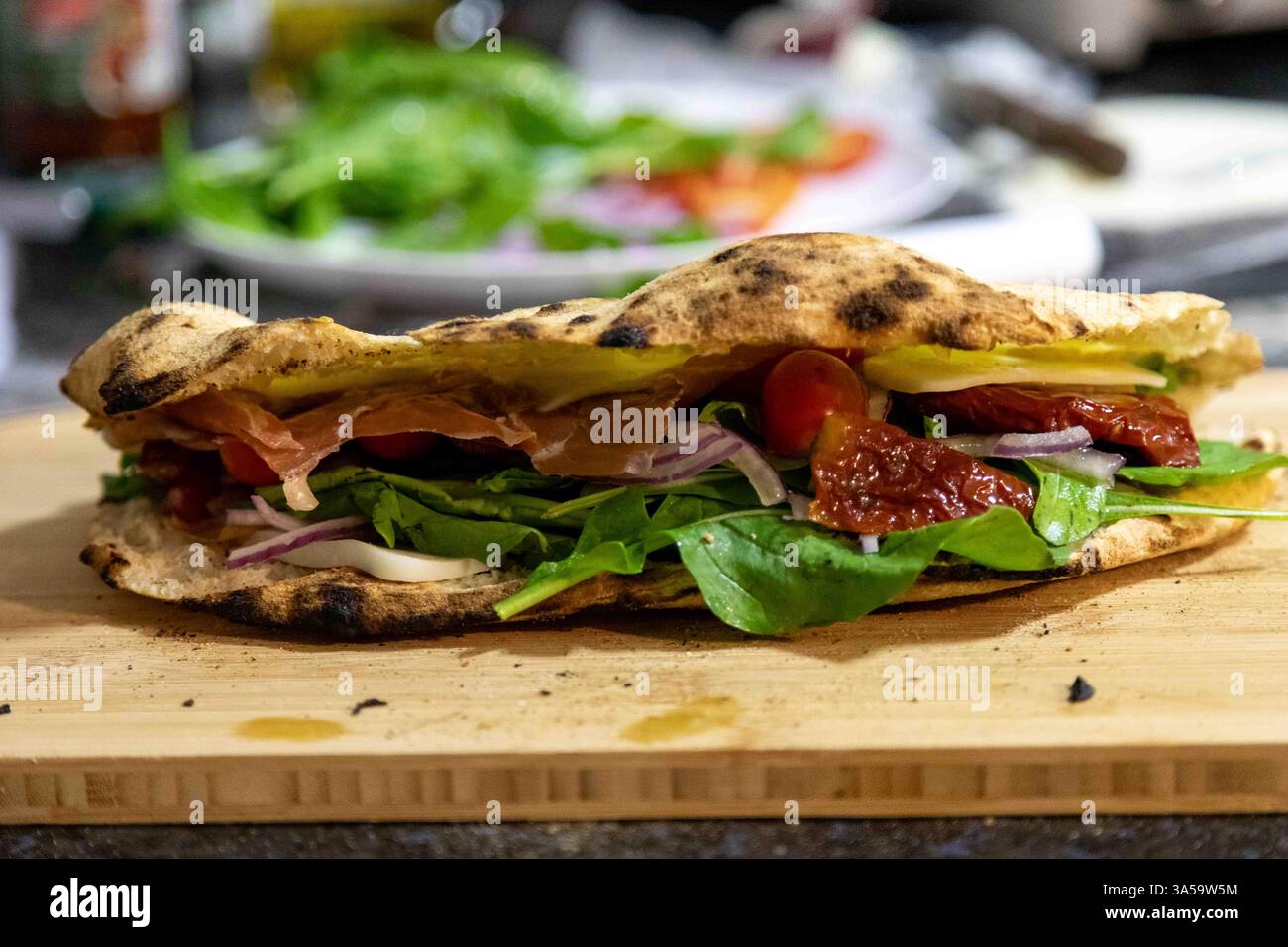 Traditional Italian Neapolitan panuozzo prepared with artisanal pizza ...