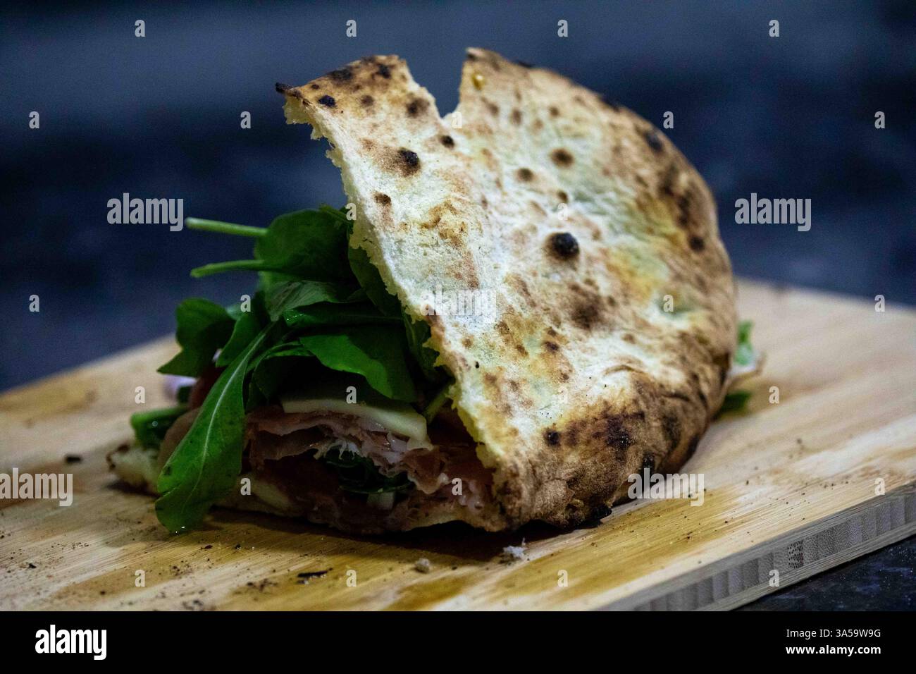 Traditional Italian Neapolitan panuozzo prepared with artisanal pizza ...