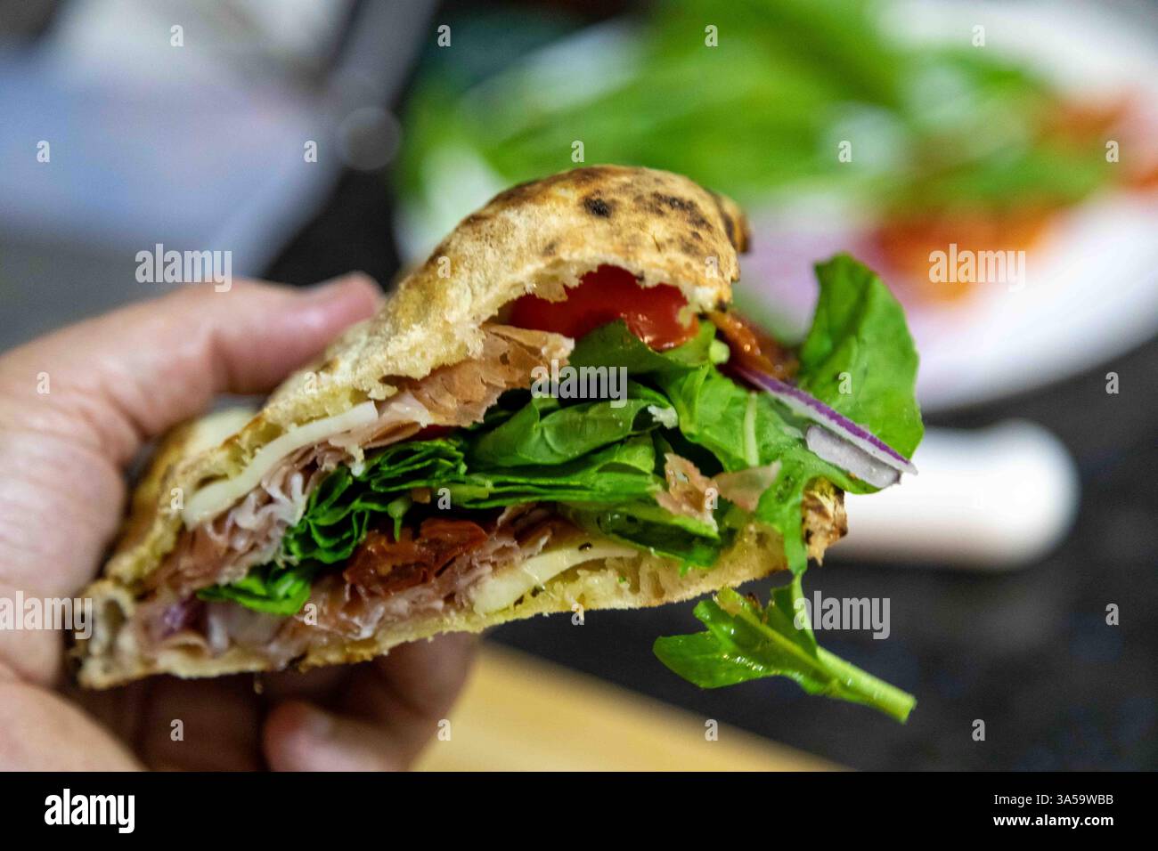 Traditional Italian Neapolitan panuozzo prepared with artisanal pizza ...