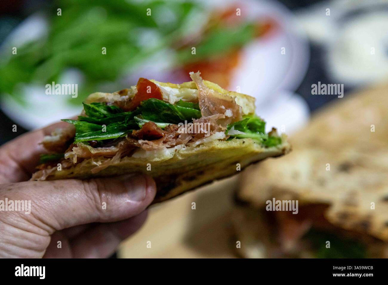 Traditional Italian Neapolitan panuozzo prepared with artisanal pizza ...