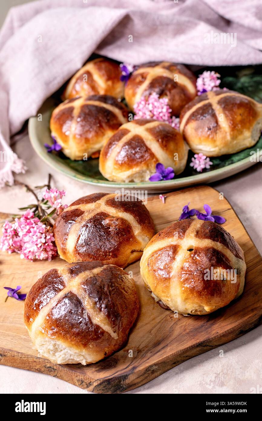 Traditional hot cross buns on wooden board. Easter baking with spices ...