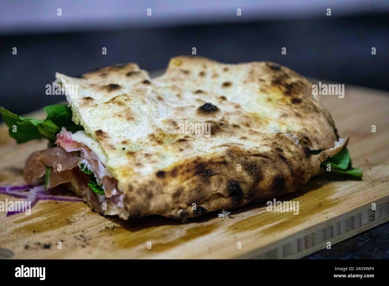 Traditional Italian Neapolitan panuozzo prepared with artisanal pizza ...