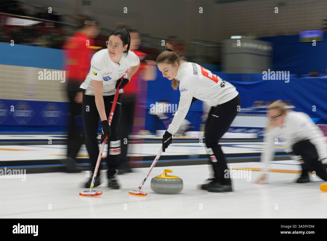 Switzerland's Carole Howald, left, and Selina Witschonke, right, sweep ...