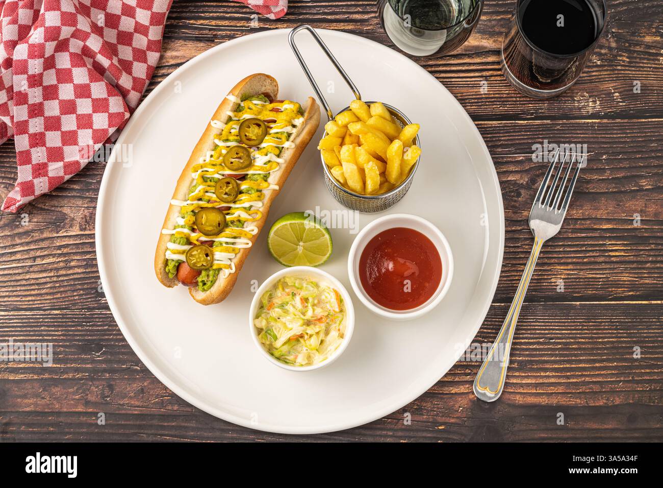Delicious hot dog sandwich with sauces and fries on the side Stock ...
