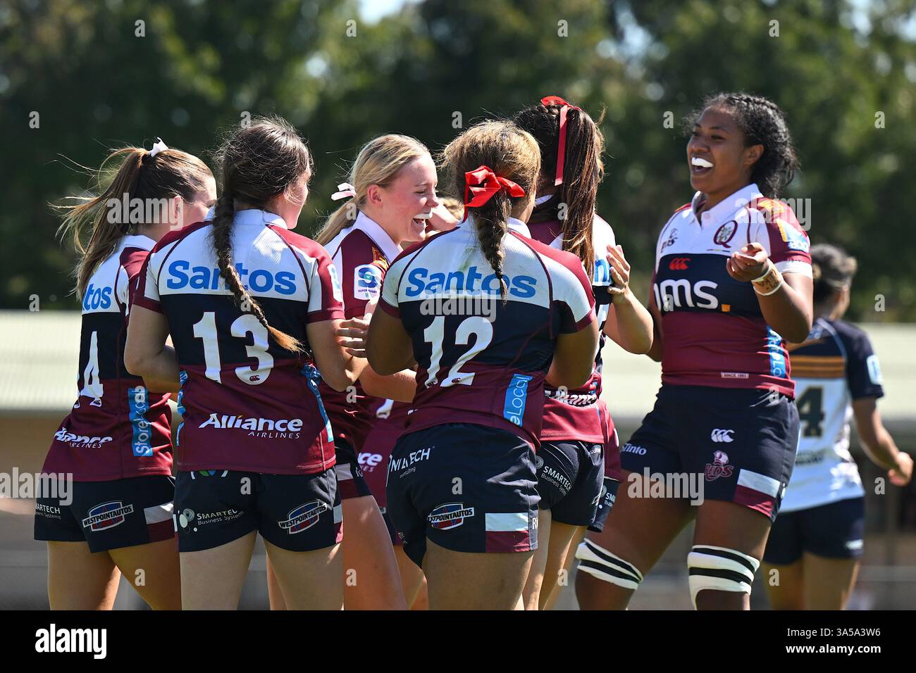 Piper Flynn of the Reds celebrates with team mates after scoring a try ...