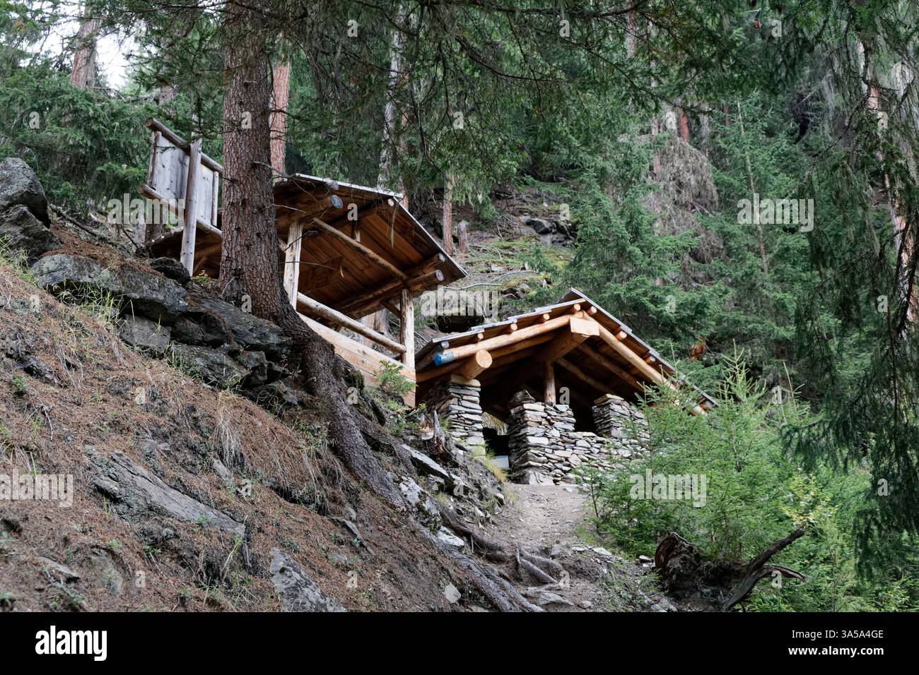 Reconstructed huts in steep ground on the miners steep track in the ...