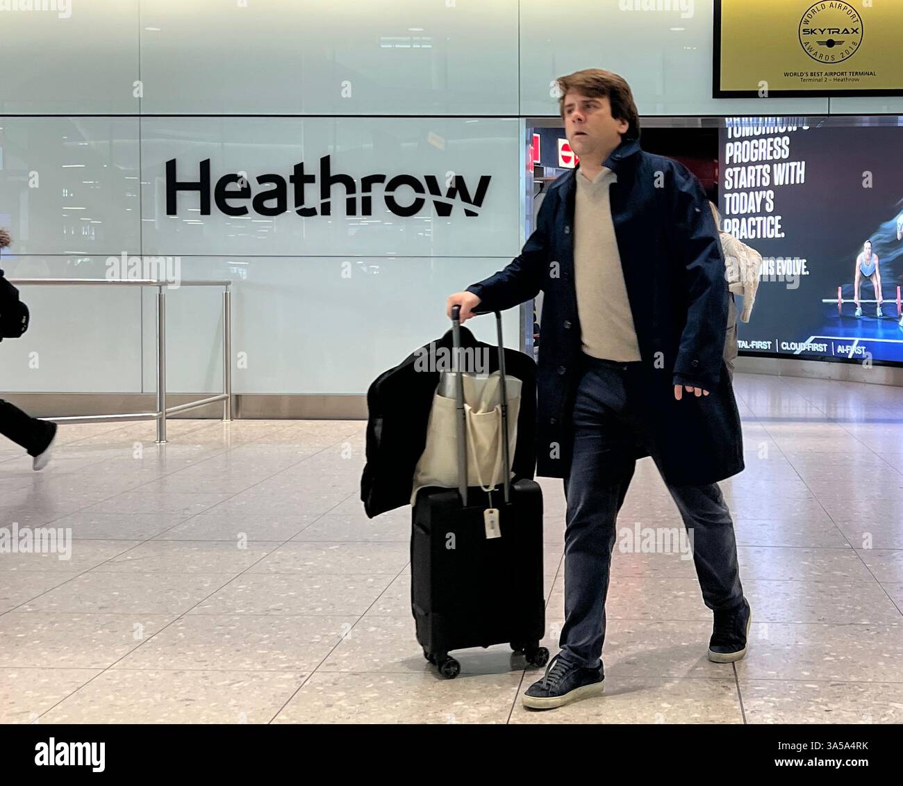 Passengers arrive from an incoming flight at Heathrow Terminal 2 in ...