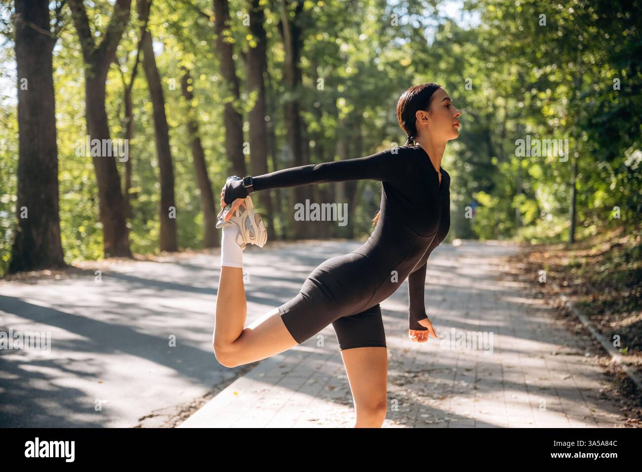 Preparing for jogging, warm up exercises. Young sportive skinny woman ...