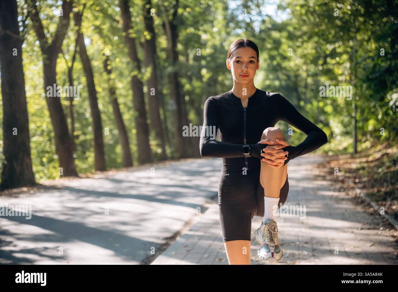 Preparing for jogging, warm up exercises. Young sportive skinny woman ...