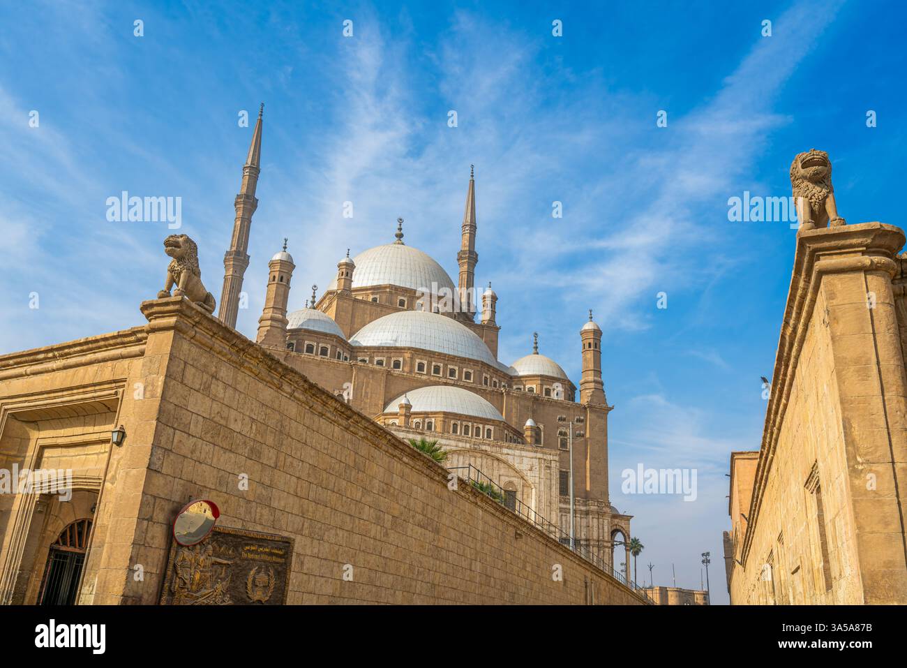 The grand Mohamed Ali Mosque in Cairo, Egypt, with its domes and minarets, stands against a ...