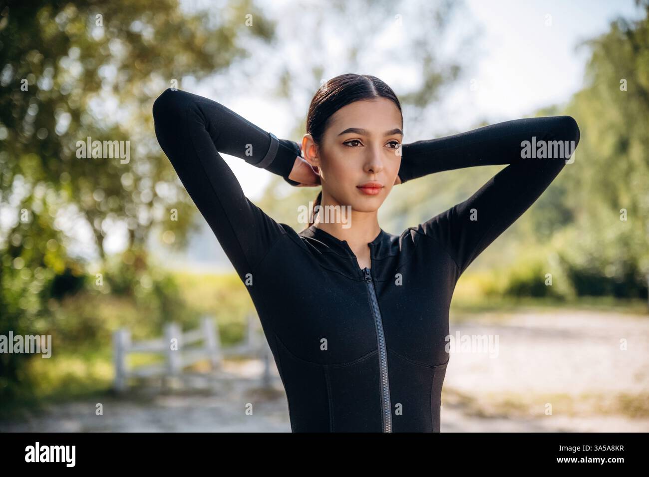 Making the ponytail, preparing for exercises. Young sportive skinny ...