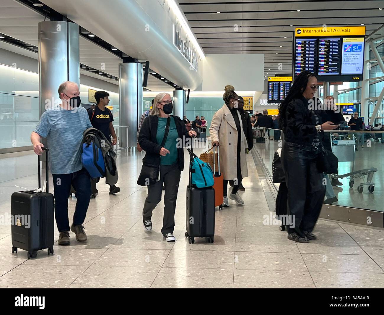 Passengers arrive from an incoming flight at Heathrow Terminal 2 in ...