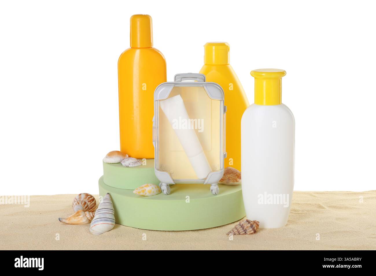 Different sun protection products and seashells on sand against white ...