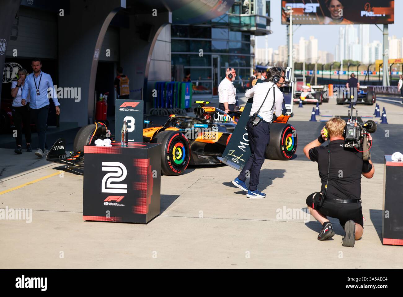 FIA personnel changing the #2 and #3 signs on the pit lane after ...
