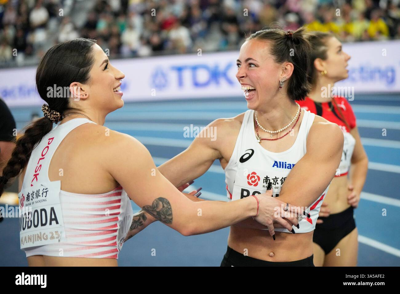 Ewa Swoboda, of Poland, and Rani Rosius, of Belgium, react after finishing their women's 60 ...