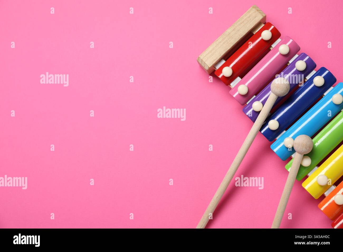 Colorful toy xylophone with mallets on pink background, top view. Space for text Stock Photo - Alamy